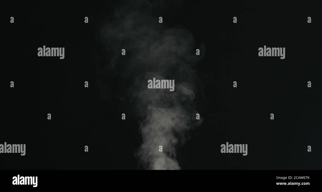 water mist stream over black background Stock Photo - Alamy