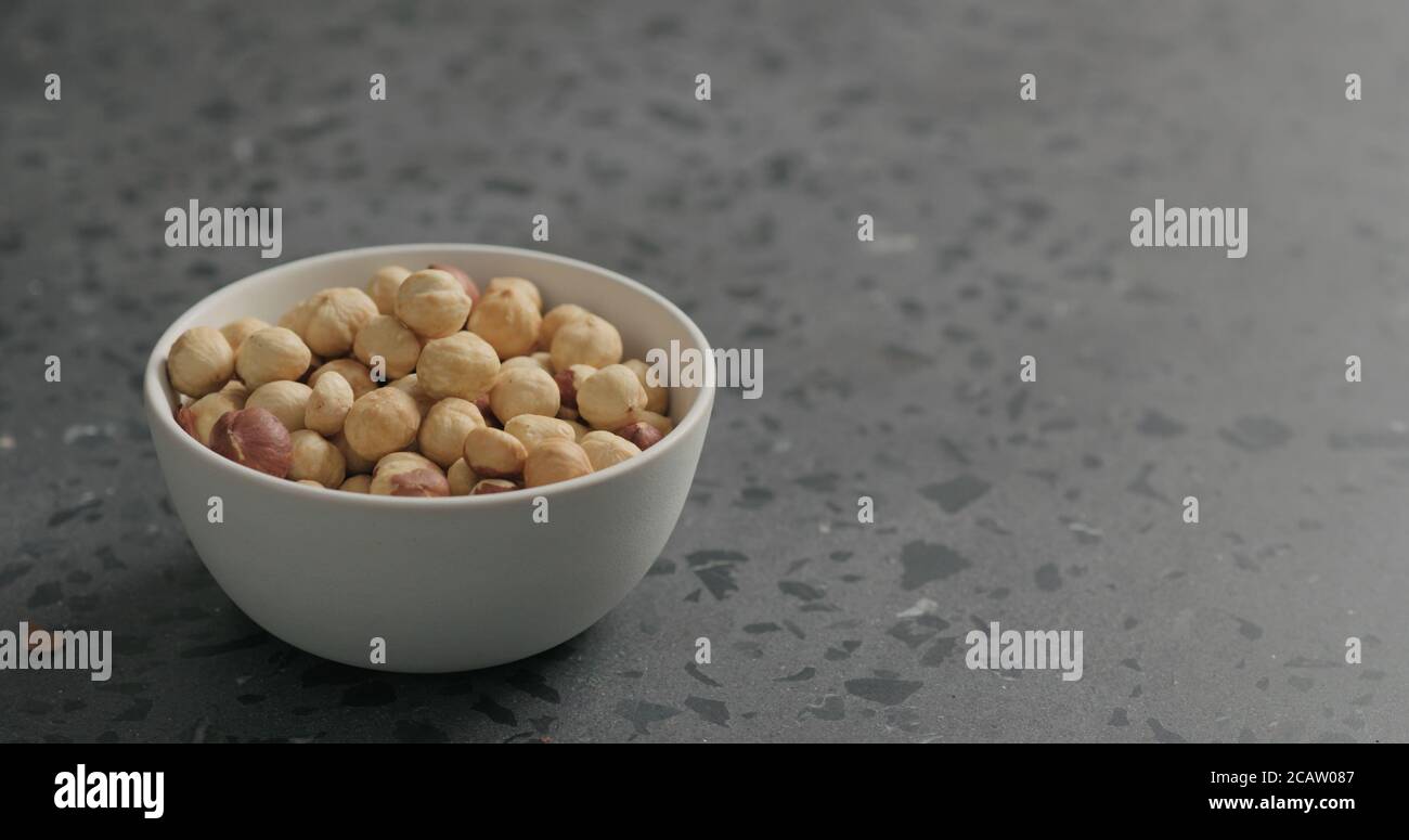 roasted hazelnuts in white bowl on terrazzo countertop Stock Photo - Alamy