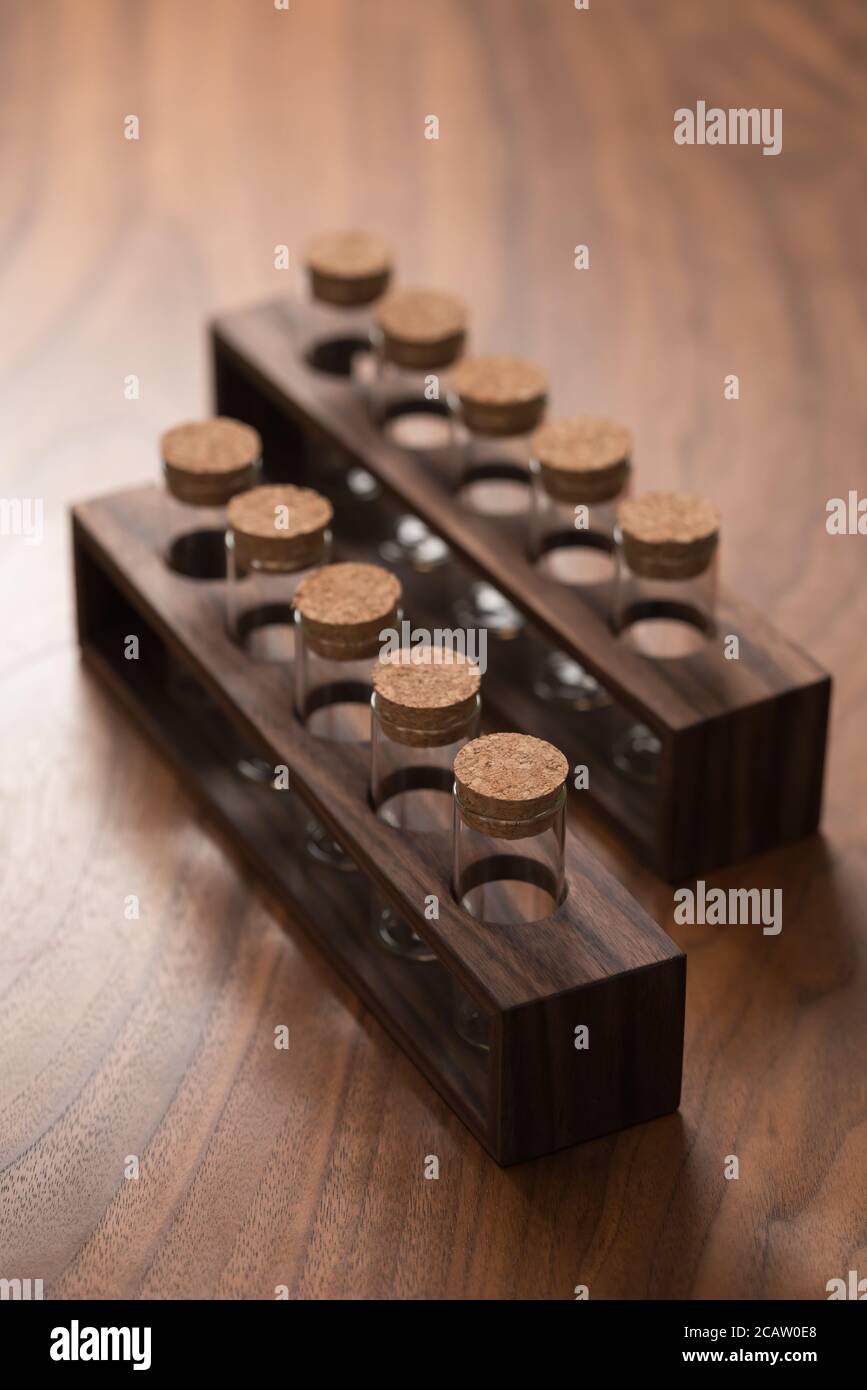 empty walnut holder with glass tubes for spices on walnut table surface ...