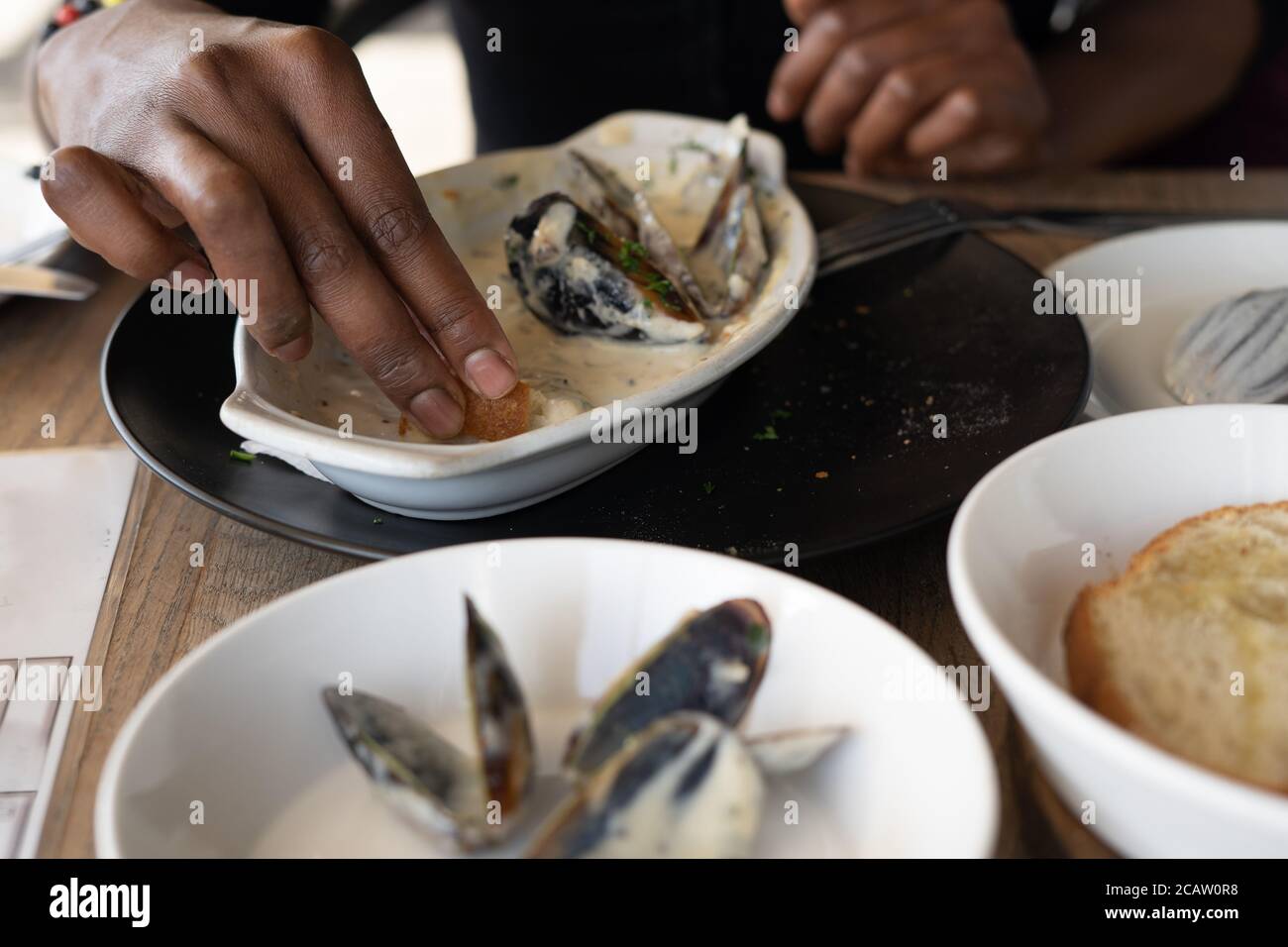 Woman eating food with her hand Stock Photo - Alamy