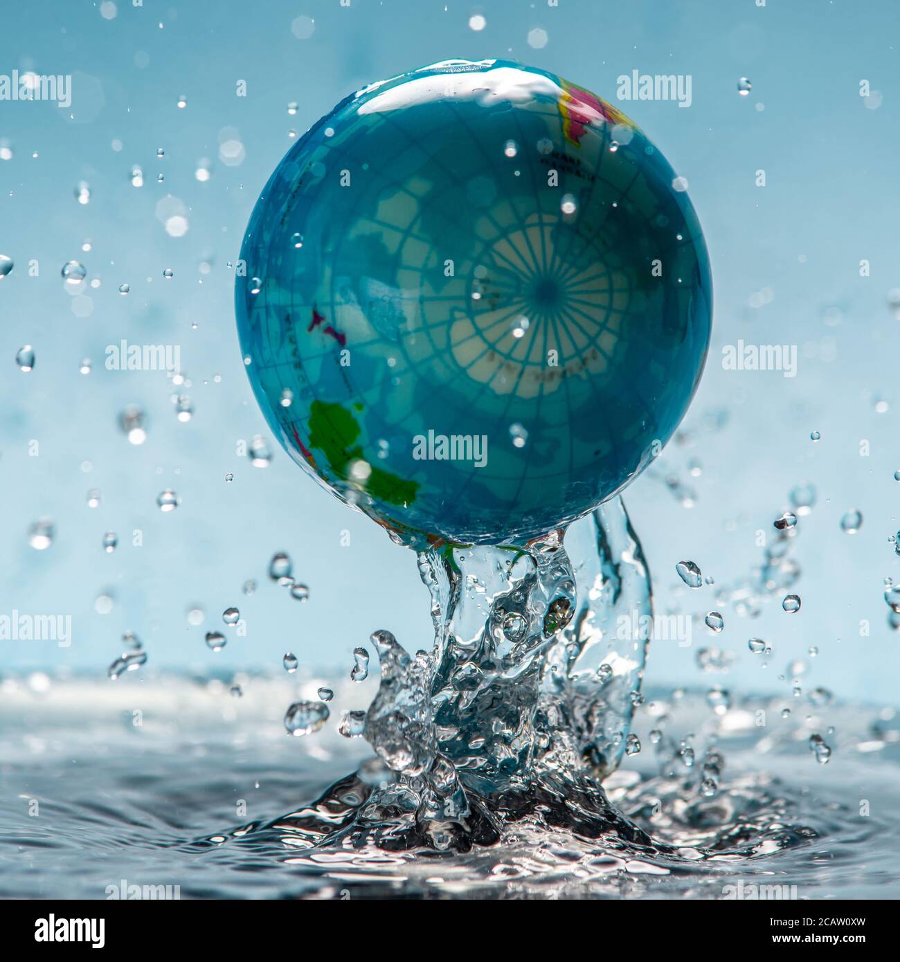Planet Earth in the form of a globe in transparent water with splashes ...
