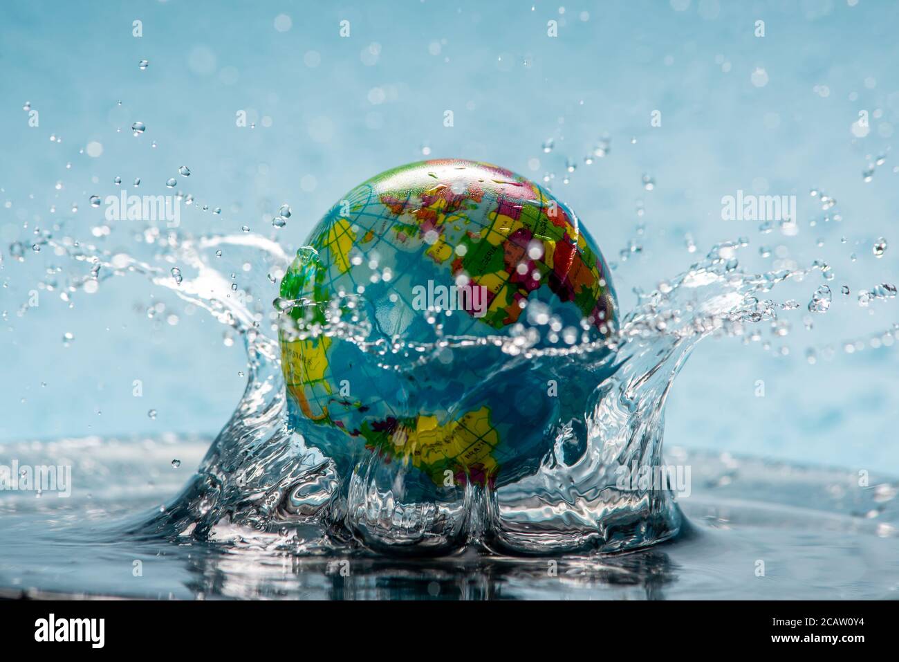 Planet Earth in the form of a globe in transparent water with splashes ...