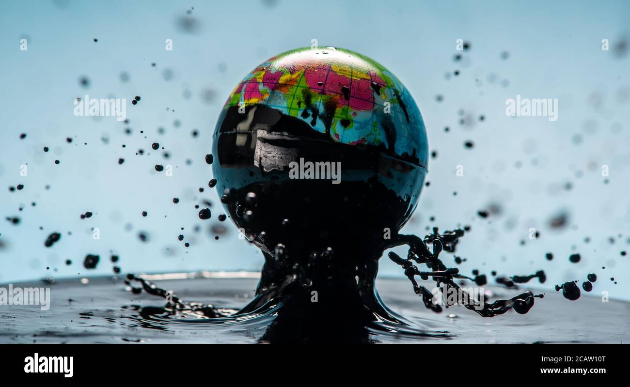 Earth in the form of a globe is falling into the oil and made a ...