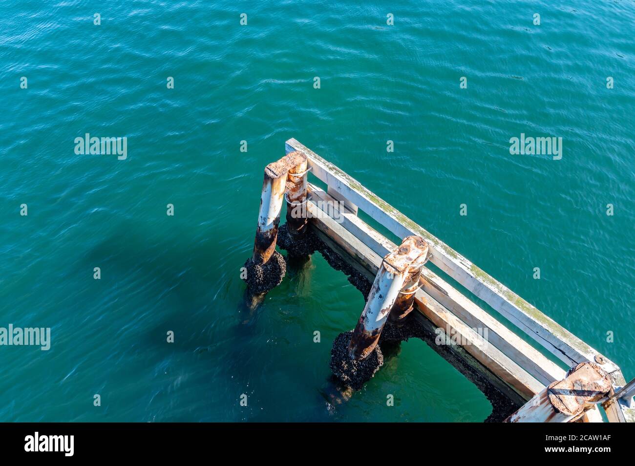 Rusty Metal Structure with barnacles in the harbour for Vessels on a ...