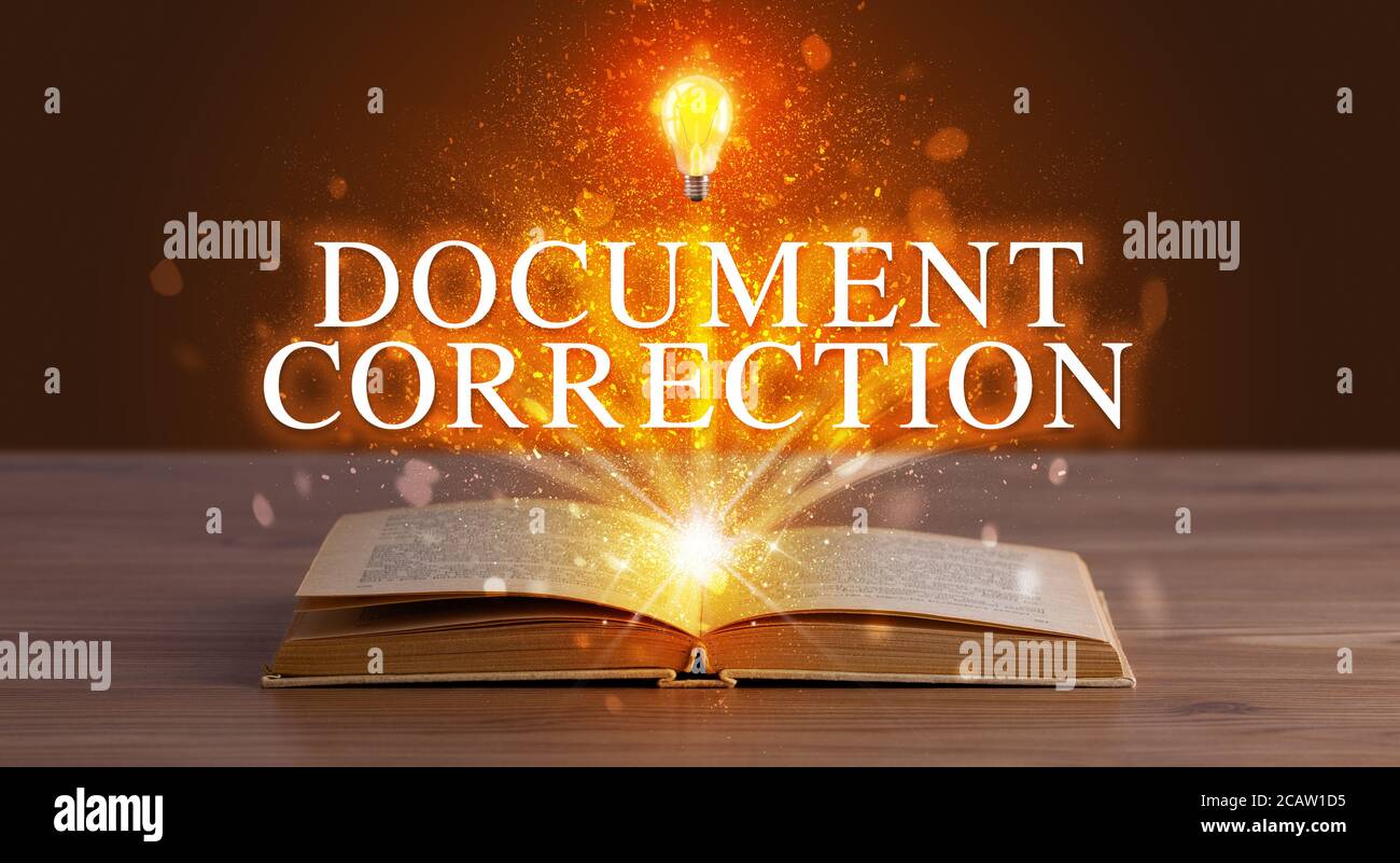 DOCUMENT CORRECTION inscription coming out from an open book ...