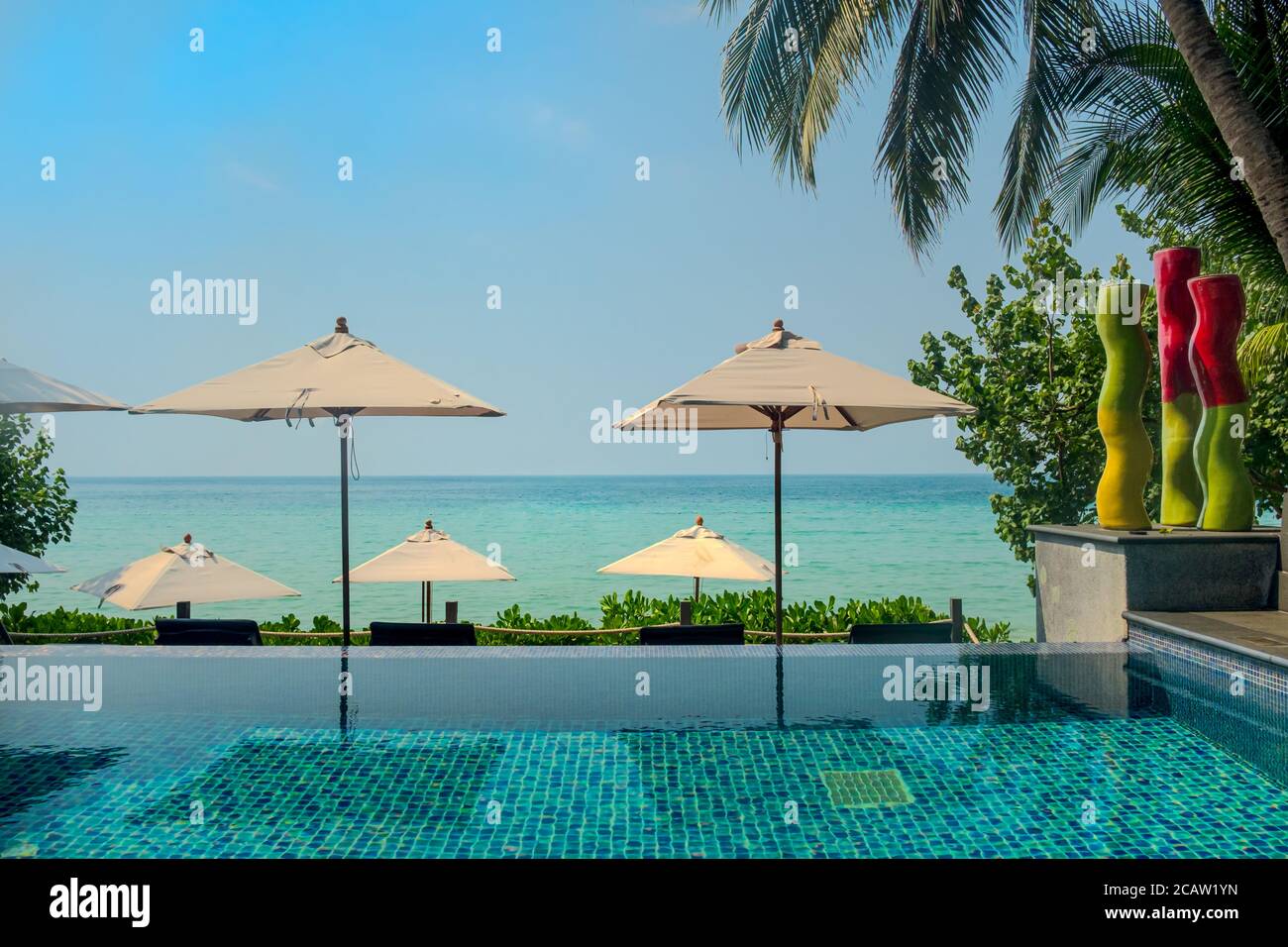 Tropical pool and sea on an island resort Stock Photo - Alamy