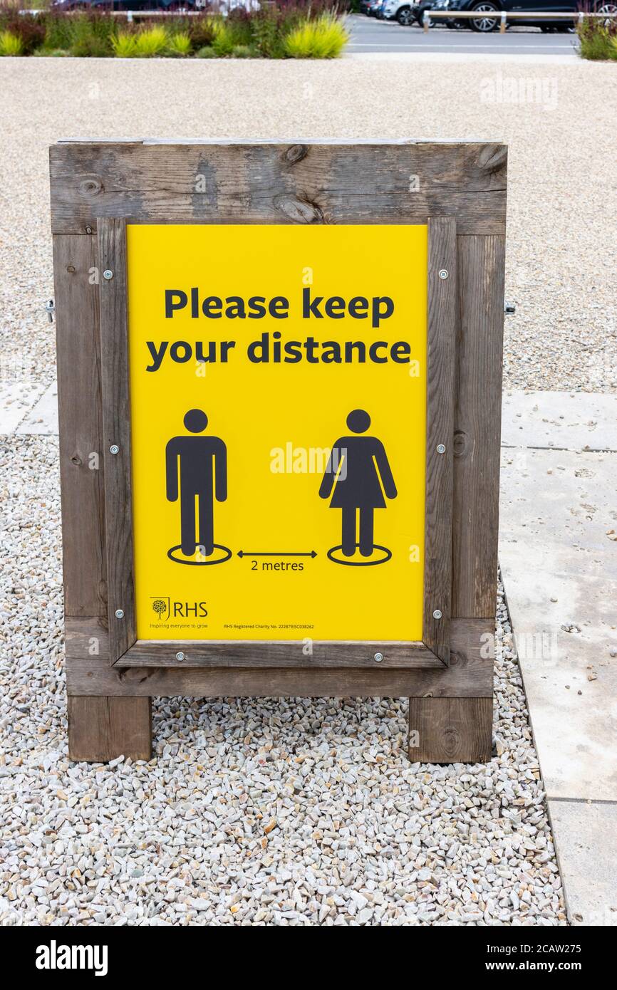 Yellow and black 2m social distancing reminder sign at RHS Garden ...