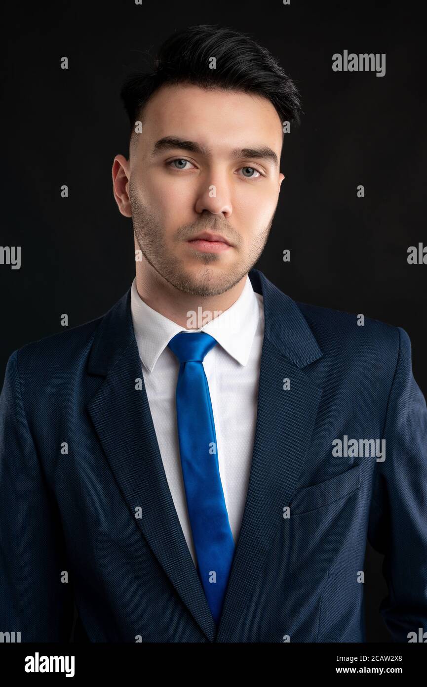 Portrait of business man wearing blue business suit and tie isolated on ...