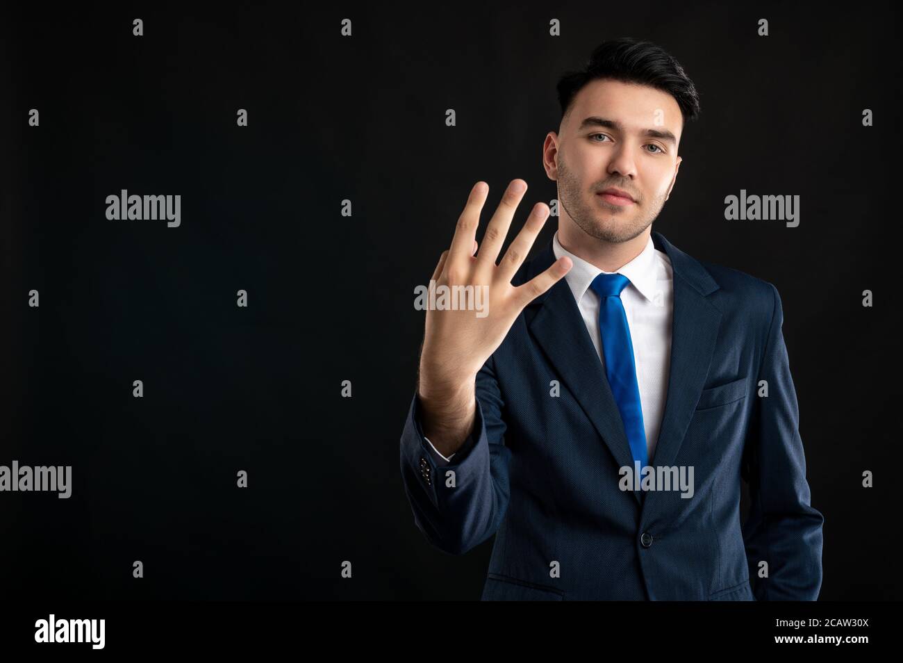 Portrait of business man wearing blue business suit and tie showing ...