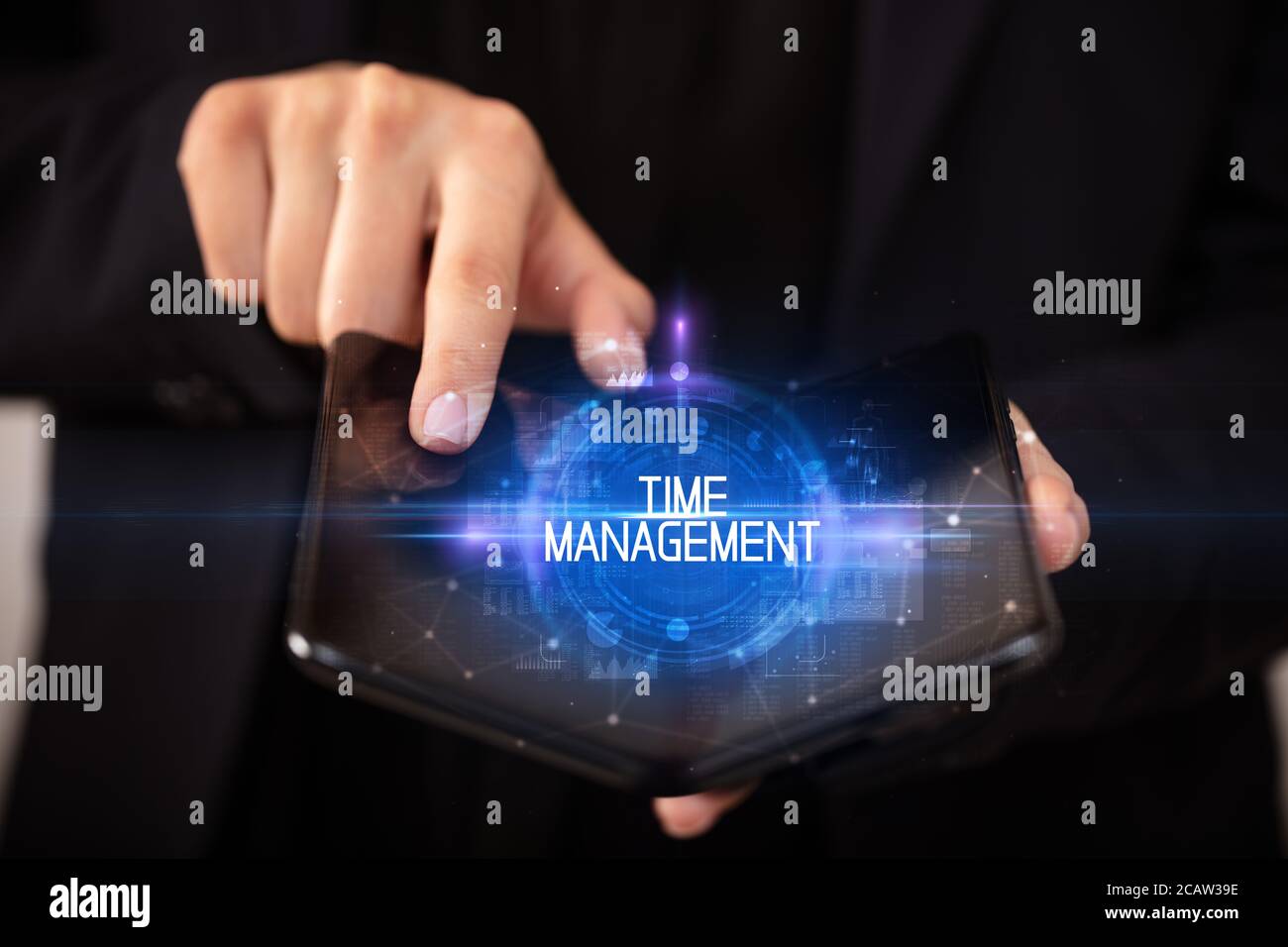 Young man holding a foldable smartphone with TIME MANAGEMENT ...