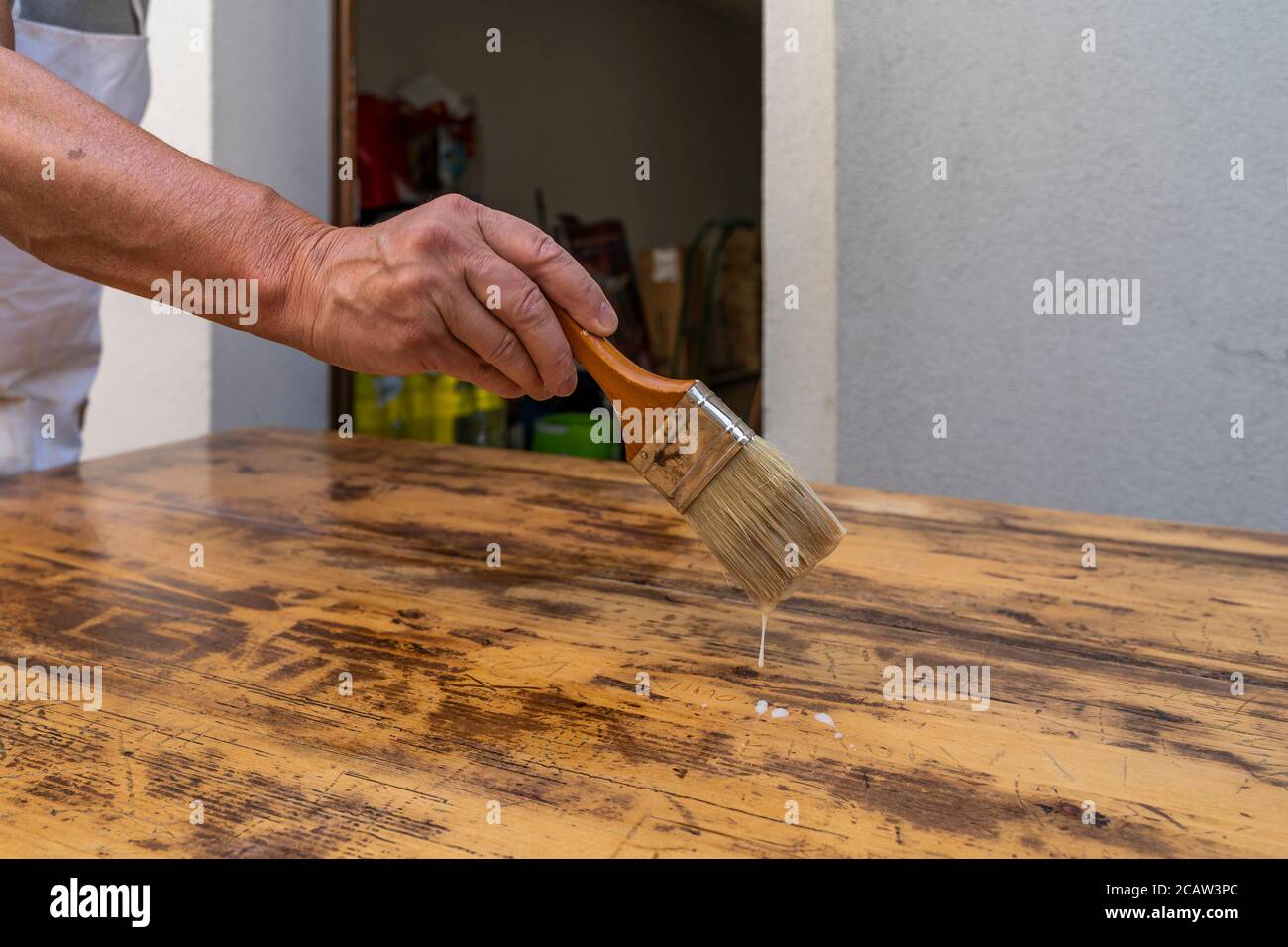 professional carpenter is building a wooden table in his outdoor ...
