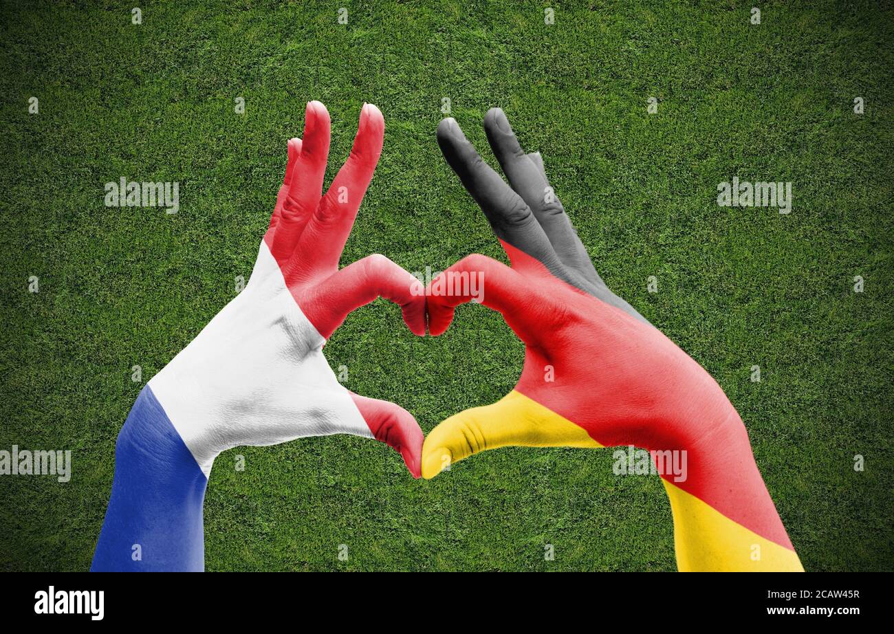 Closeup of two hands with France and Germany flag colors forming a ...