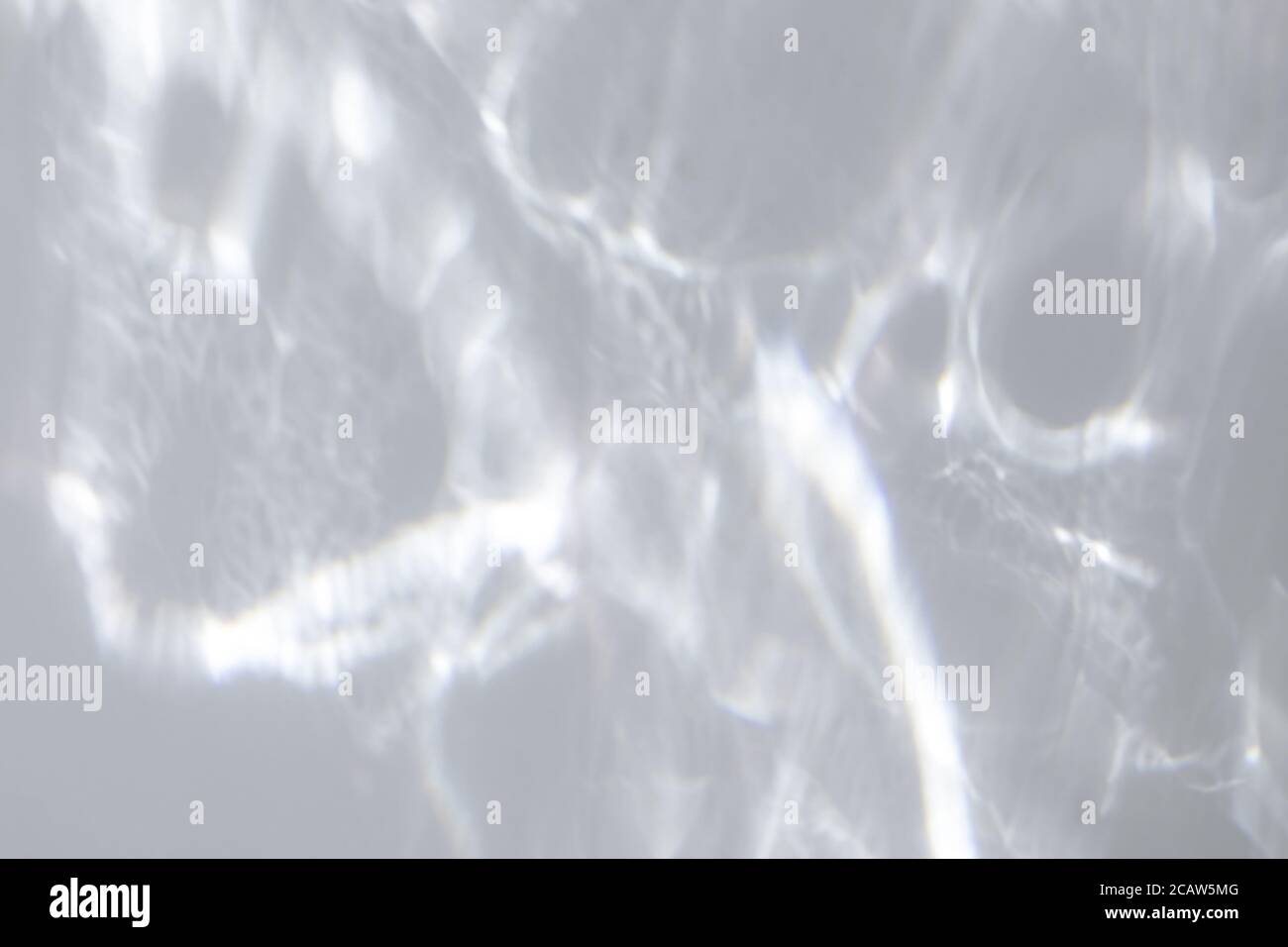 shadow and light caustic effect on a white wall Stock Photo - Alamy