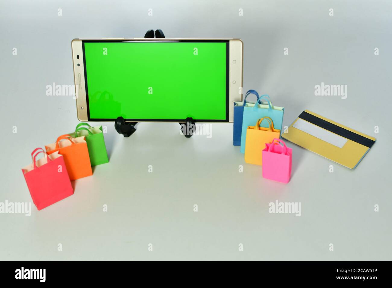 High angle shot of a cellphone with green screen, credit card, and gift ...
