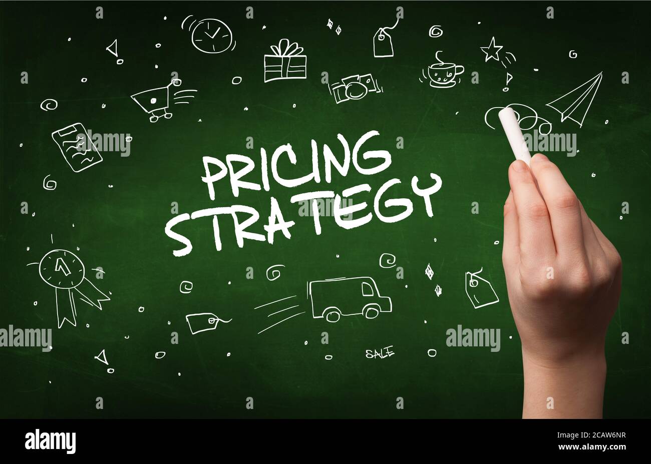 Hand drawing PRICING STRATEGY inscription with white chalk on ...
