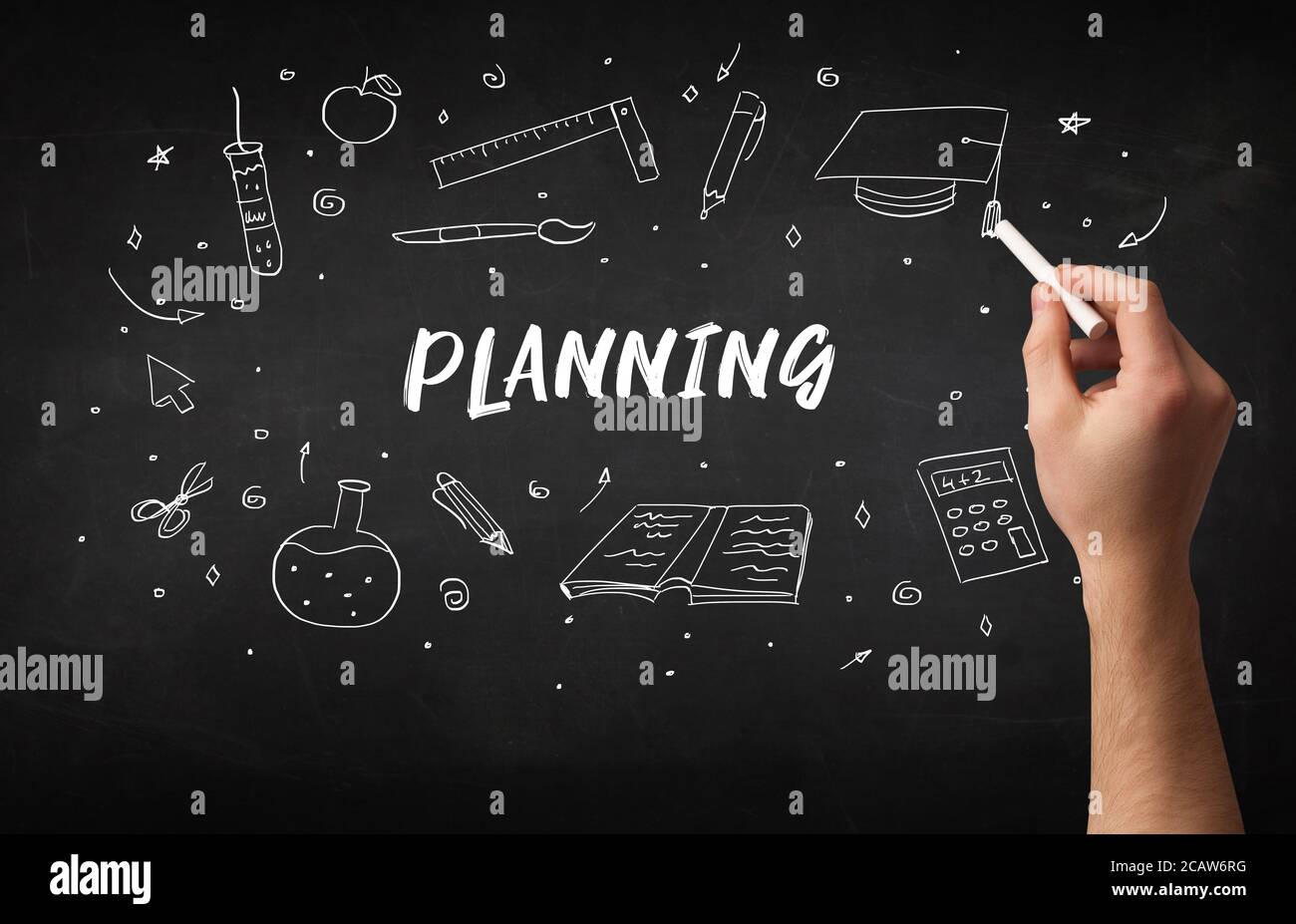 Hand drawing PLANNING inscription with white chalk on blackboard ...