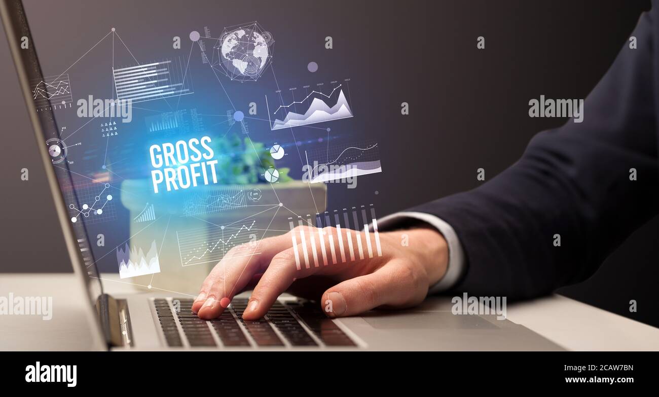 Businessman working on laptop with GROSS PROFIT inscription, new ...