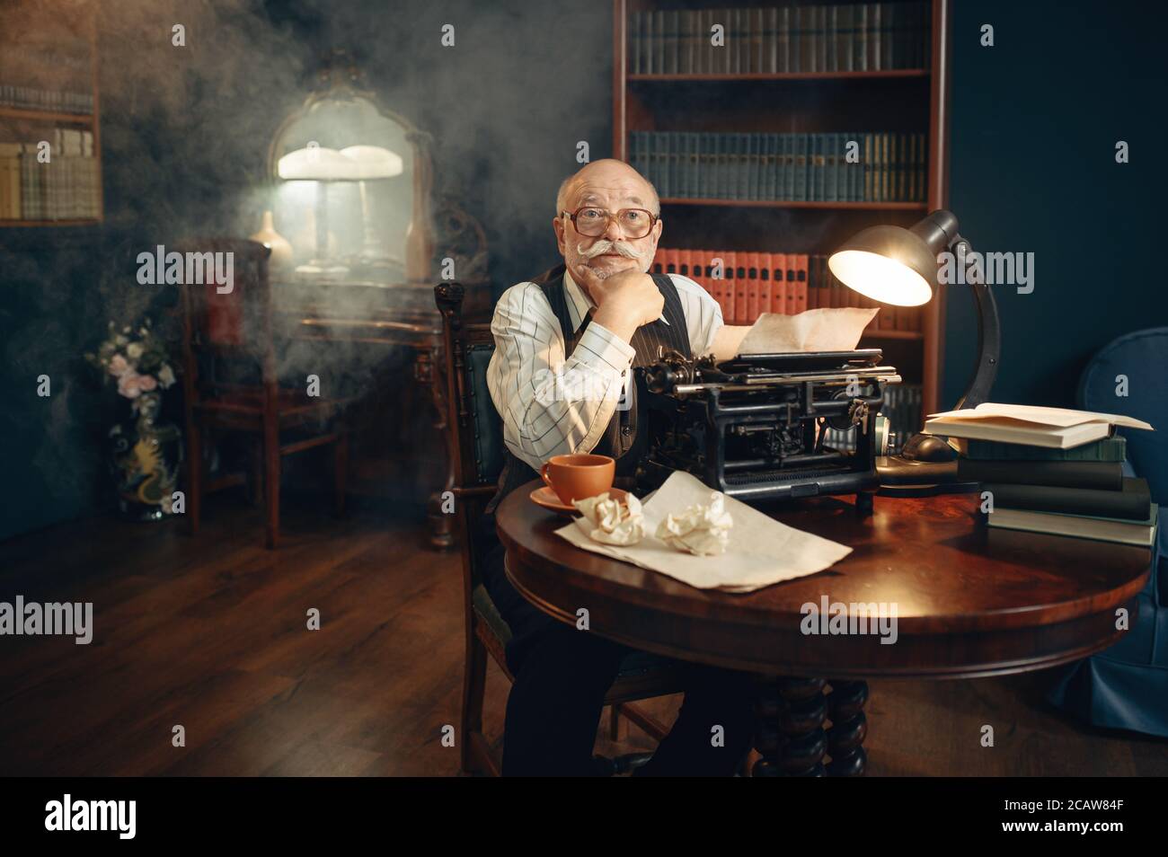 Elderly writer works on vintage typewriter Stock Photo - Alamy