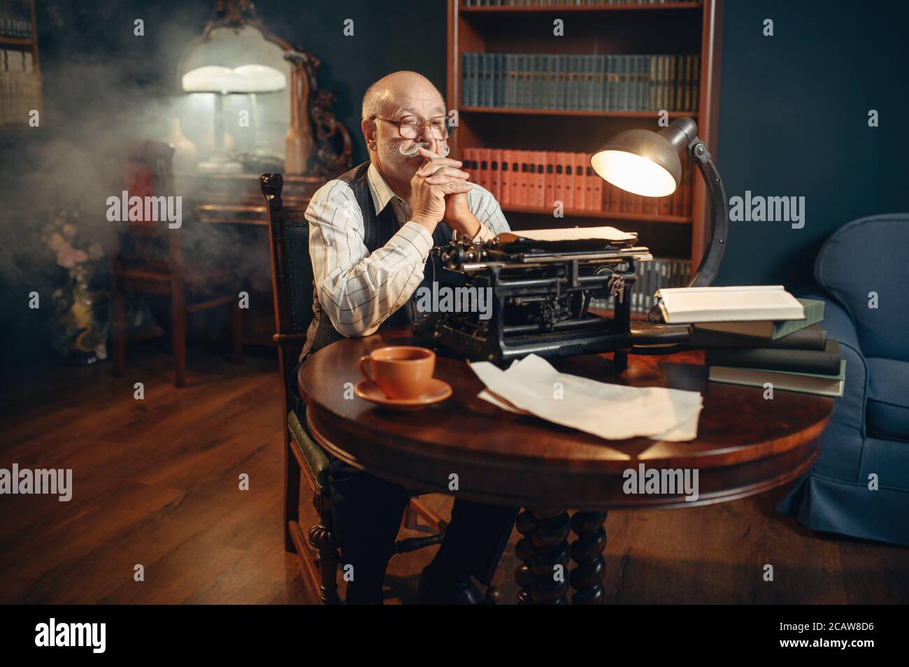 Elderly writer thinks at vintage typewriter Stock Photo - Alamy