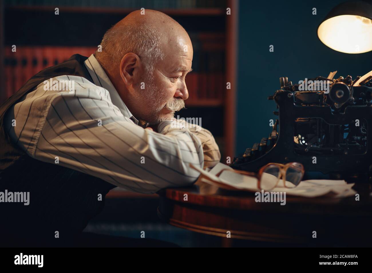 Elderly writer thinks at vintage typewriter Stock Photo - Alamy