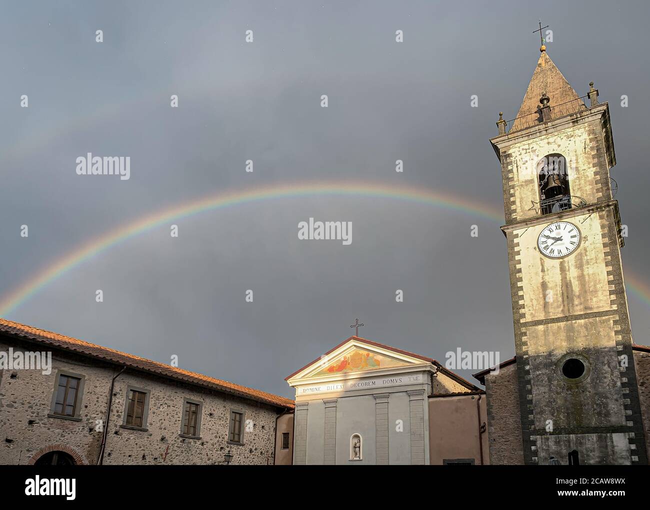 Beautiful rainbow over a medieval Catholic church Stock Photo - Alamy
