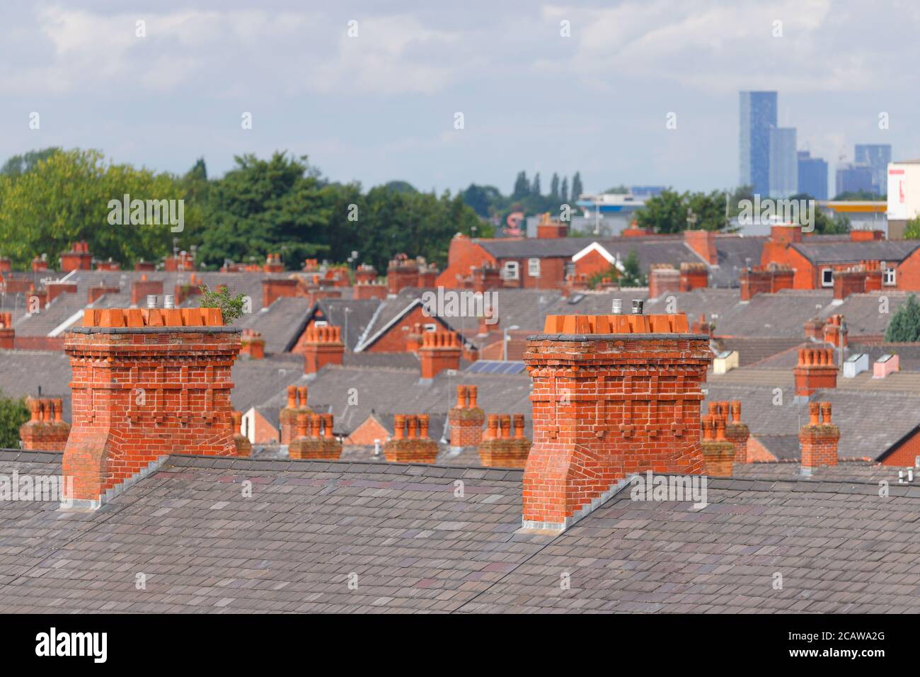 Rooftops of terraced housing in Ashton Under Lyne with a view of ...