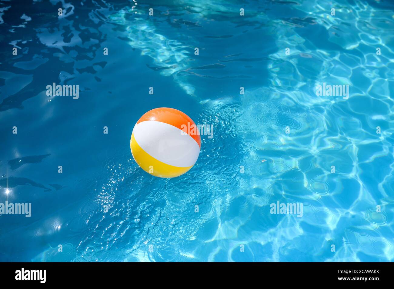 Colorful ball in blue water in the pool, nobody Stock Photo - Alamy