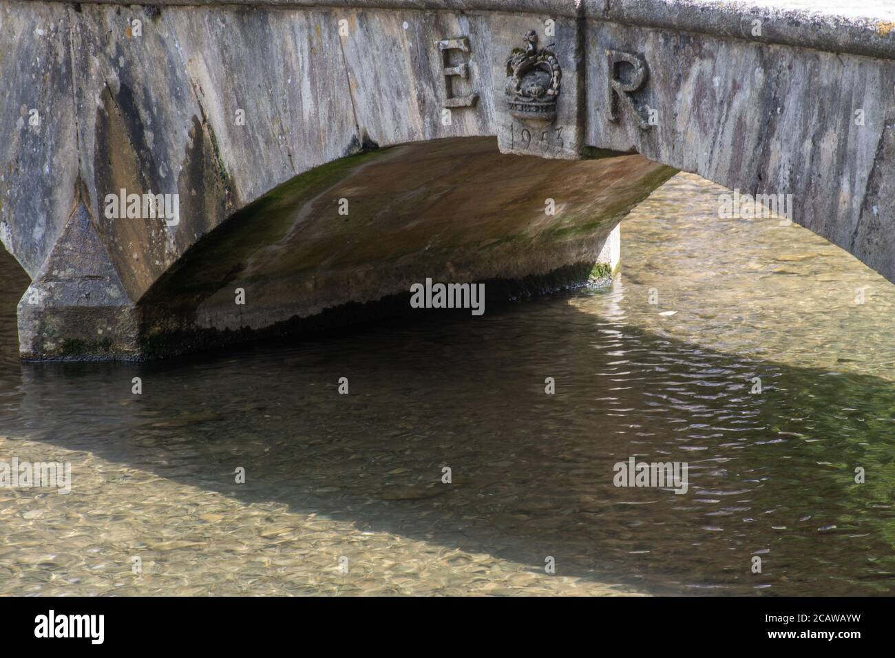 Traditional stone bridge over stream celebrating Queens Coronation ...