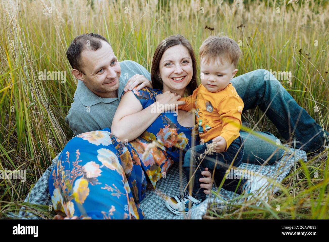 happy family having fun outdoors in grass. Family enjoying life ...