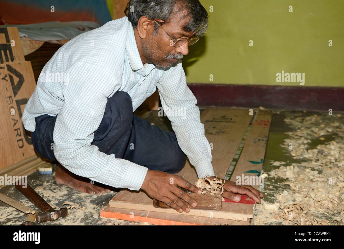 A carpenter working on wood by using old tools Stock Photo - Alamy