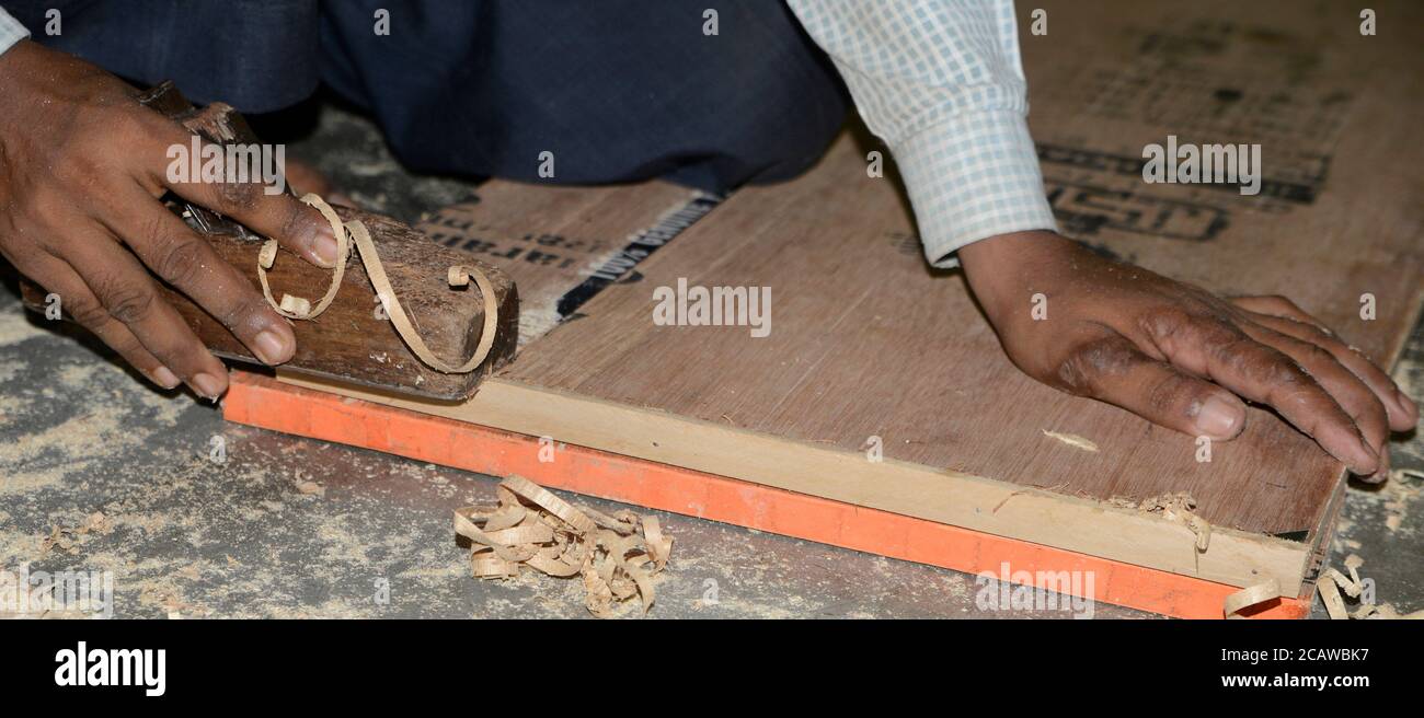 A carpenter working on wood by using old tools Stock Photo - Alamy