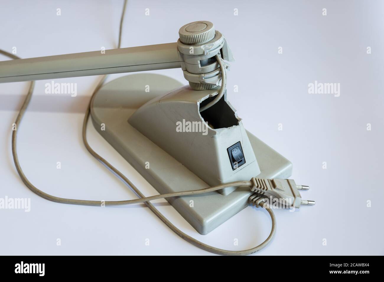 Broken table lamp on a white background Stock Photo - Alamy