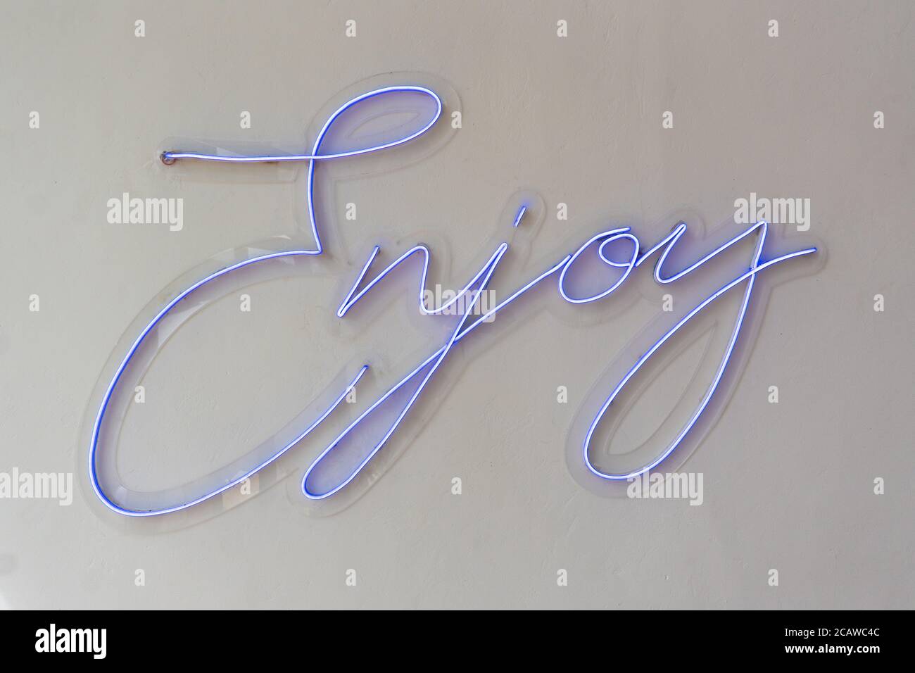 Enjoy sign. Live neon sign on the wall background Stock Photo - Alamy
