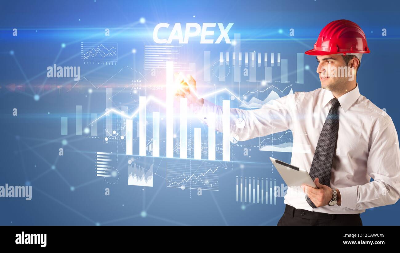 Handsome businessman with helmet drawing CAPEX inscription ...