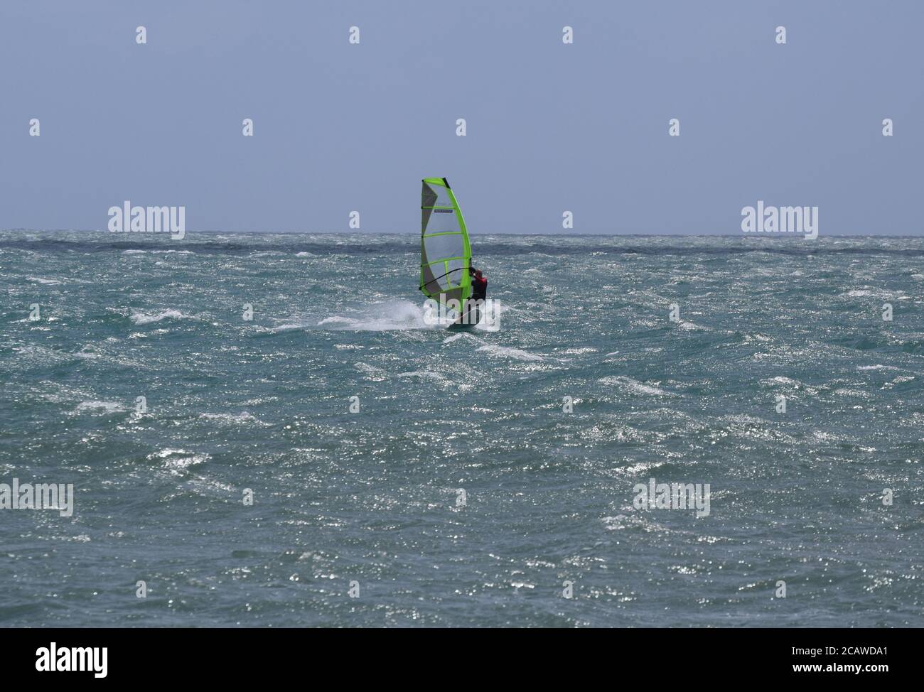 wind surfer on shimmering sea Stock Photo - Alamy