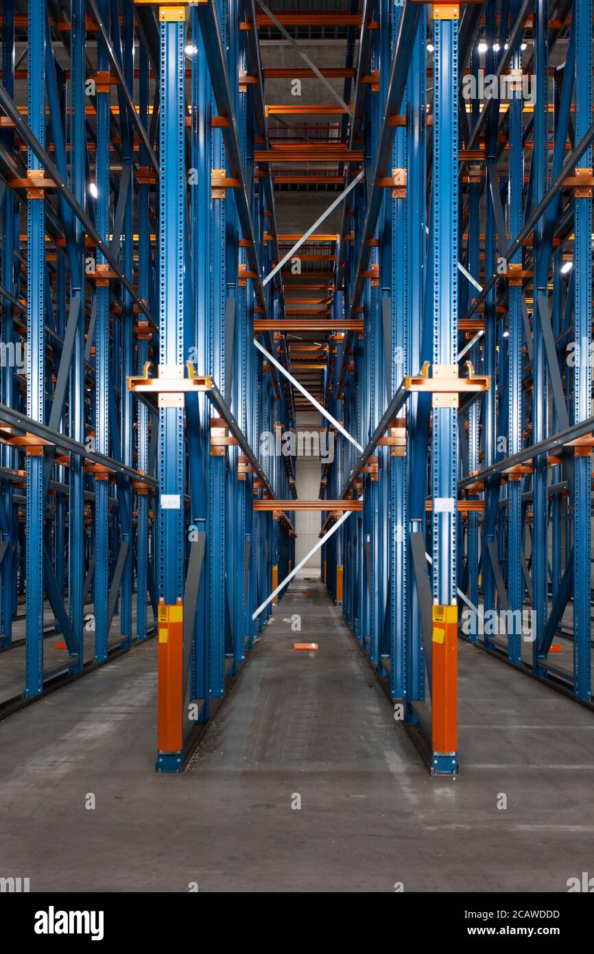 Vertical shot of empty storage racks in a warehouse Stock Photo - Alamy