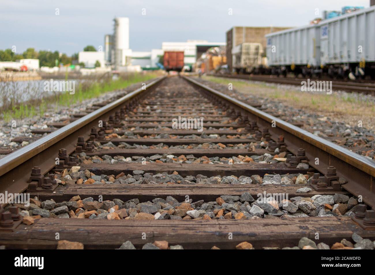 Train rails near an industrial territory Stock Photo - Alamy