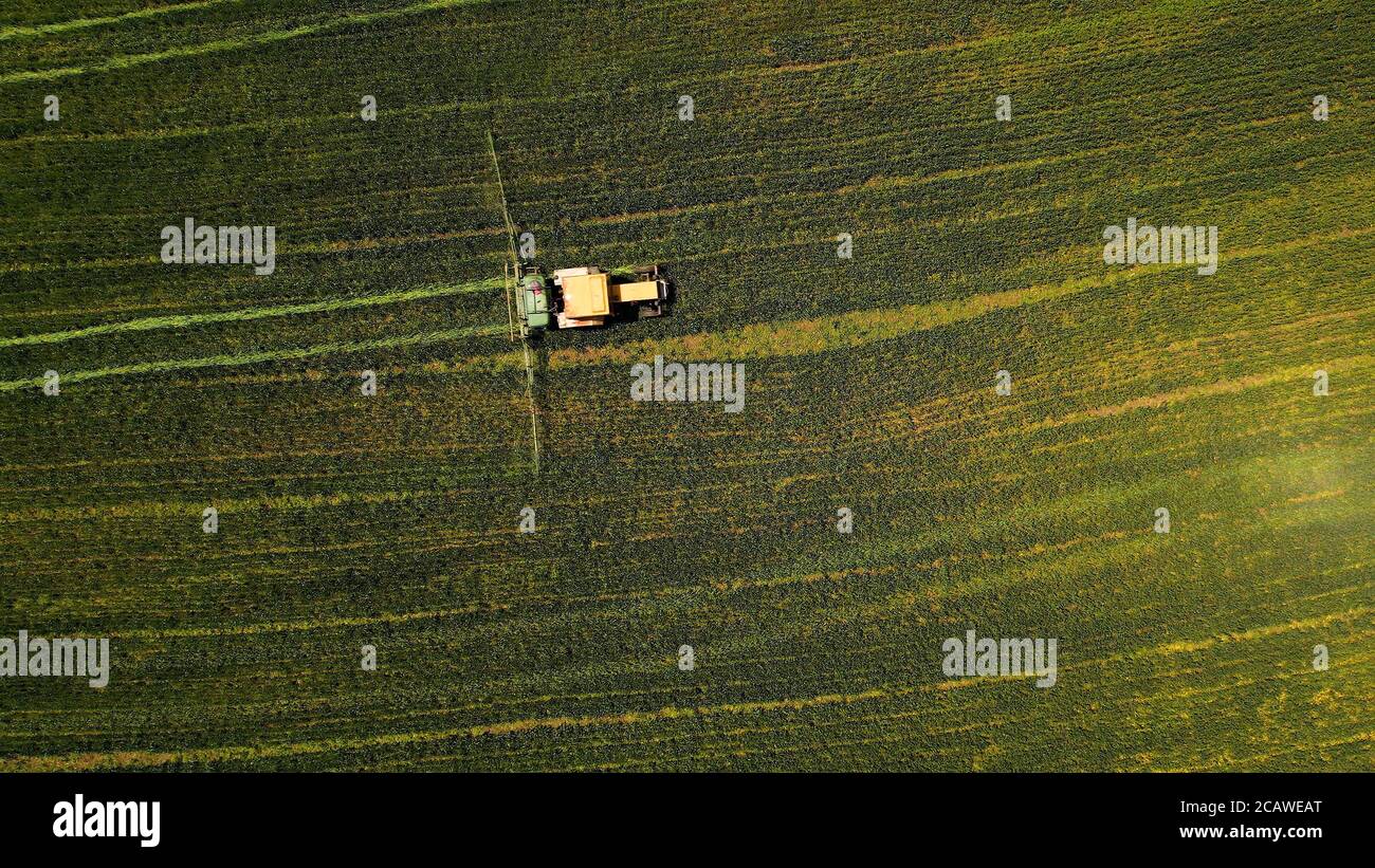 Aerial shot of a lawn mowing car in a grassland Stock Photo - Alamy