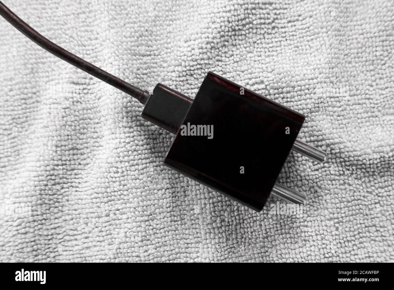 a closeup shot of electrical mobile adapter plug isolated on cloth in ...