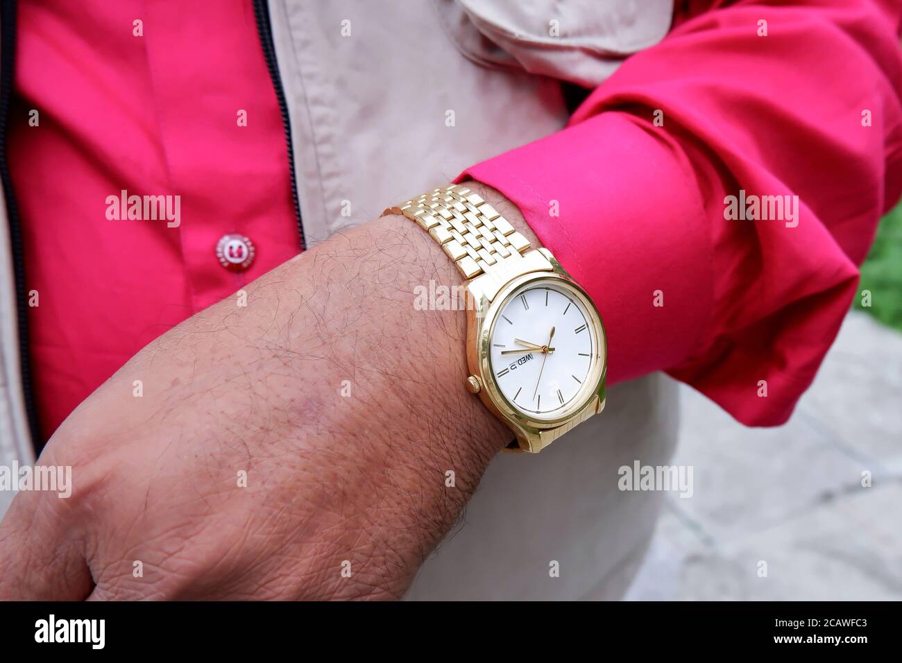a close shot of golden watch wearing handsome young man Stock Photo - Alamy