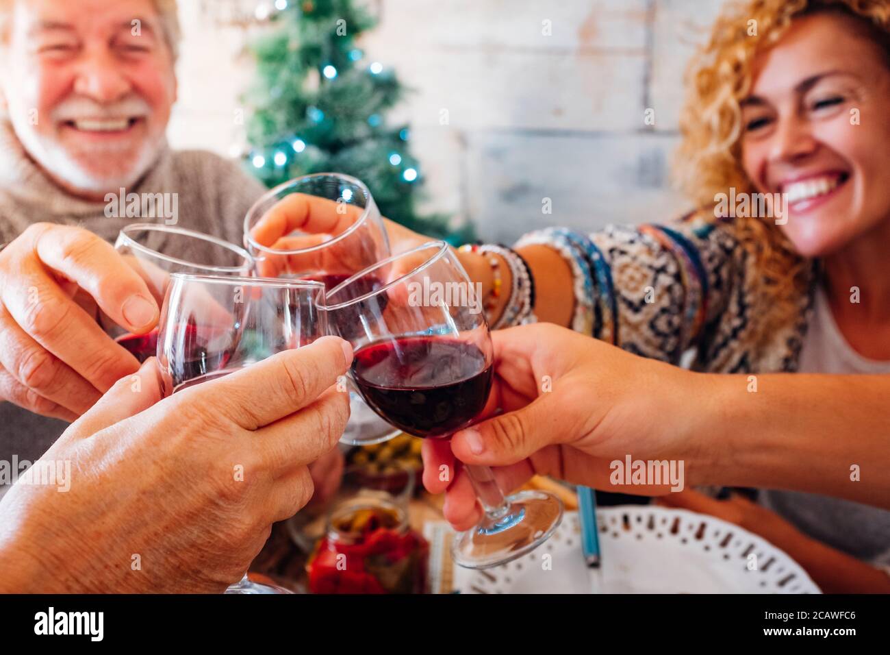 Cheerful people family and friends toasting with red wine - xmas ...