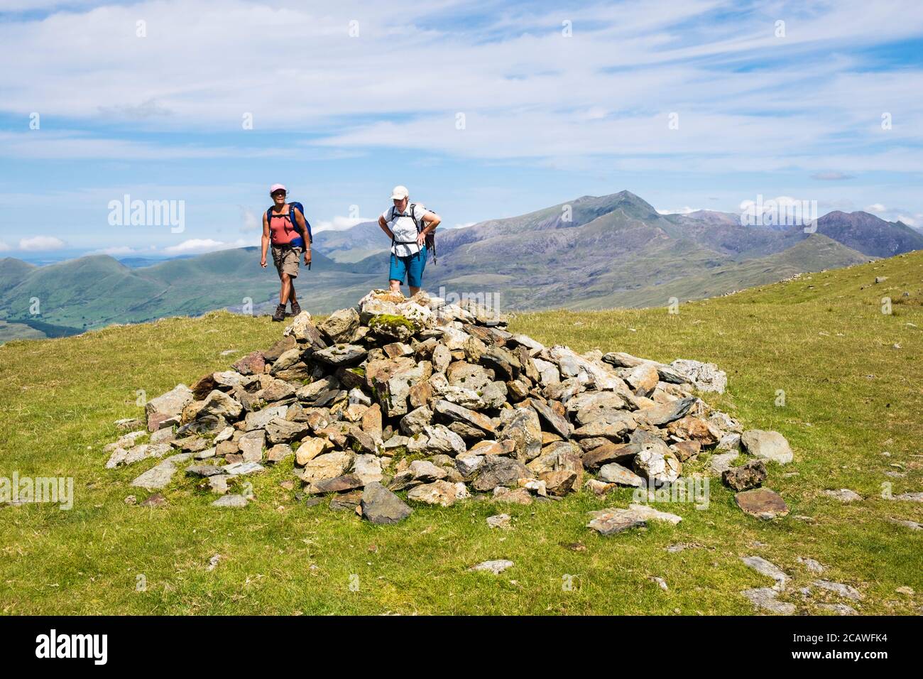 Two women hikers hiking on top of Moel Hebog mountain in mountains of ...