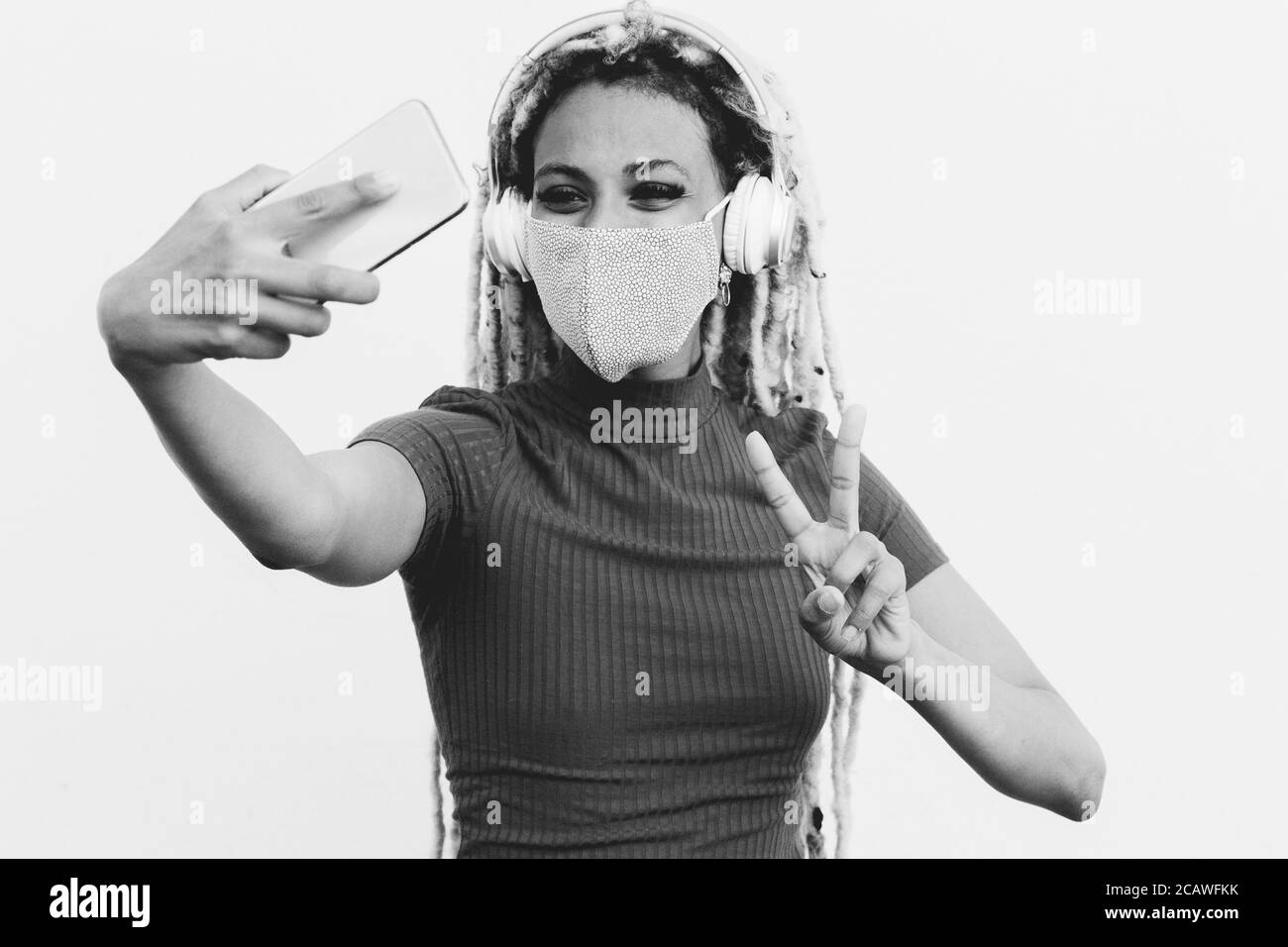 Yound african woman with blond dreadlocks doing video call with smart ...