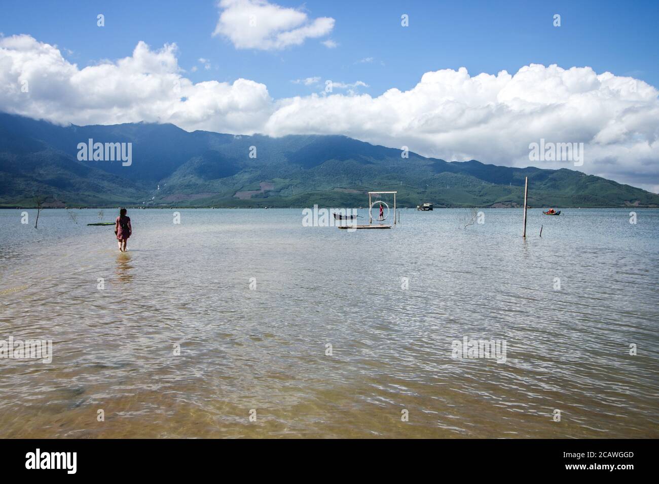 Tourists enjoying lake activities at Lang Co, Vietnam under a cloudy ...