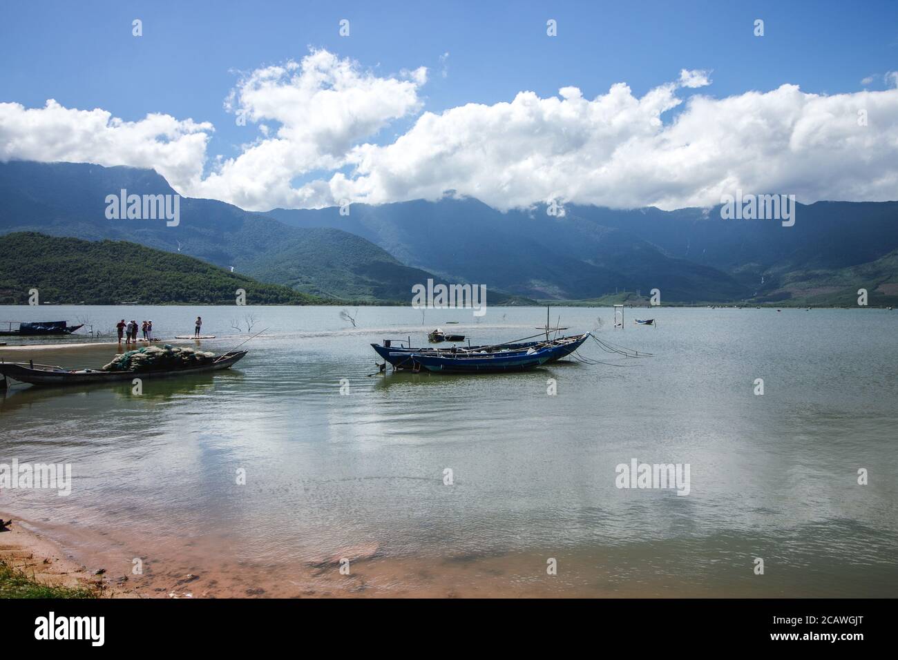 Lang Co Lake in Vietnam with tourist boats and mountains in the ...