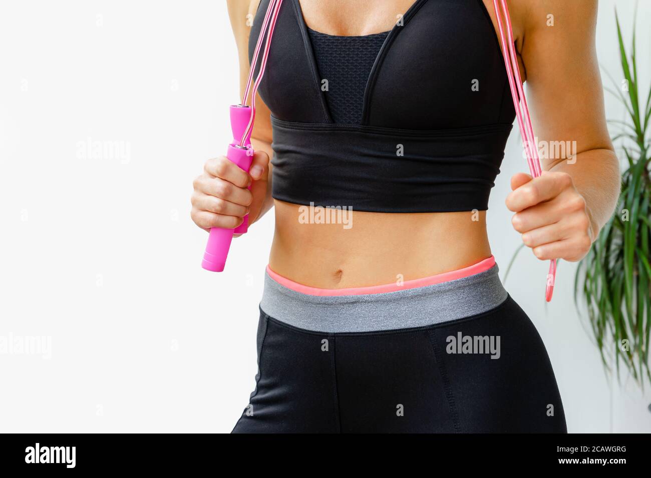 Fitness woman holding jump rope on white background. Cardio training ...