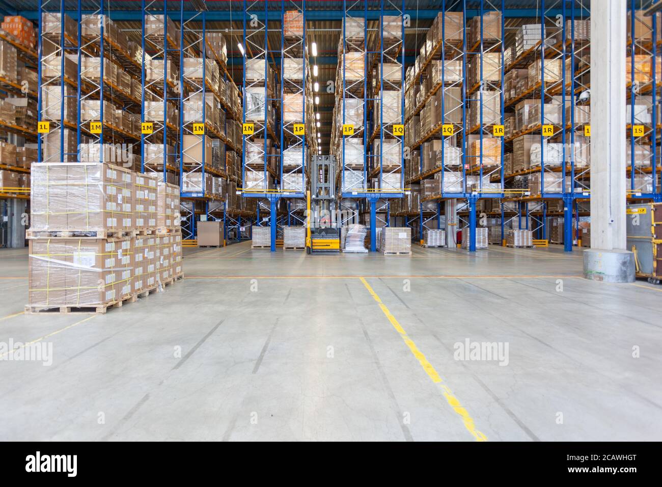 View of full warehouse with forklift Stock Photo - Alamy