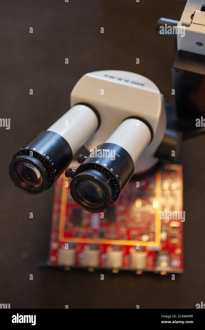 Vertical shot of microscope to repair with a circuit board Stock Photo ...