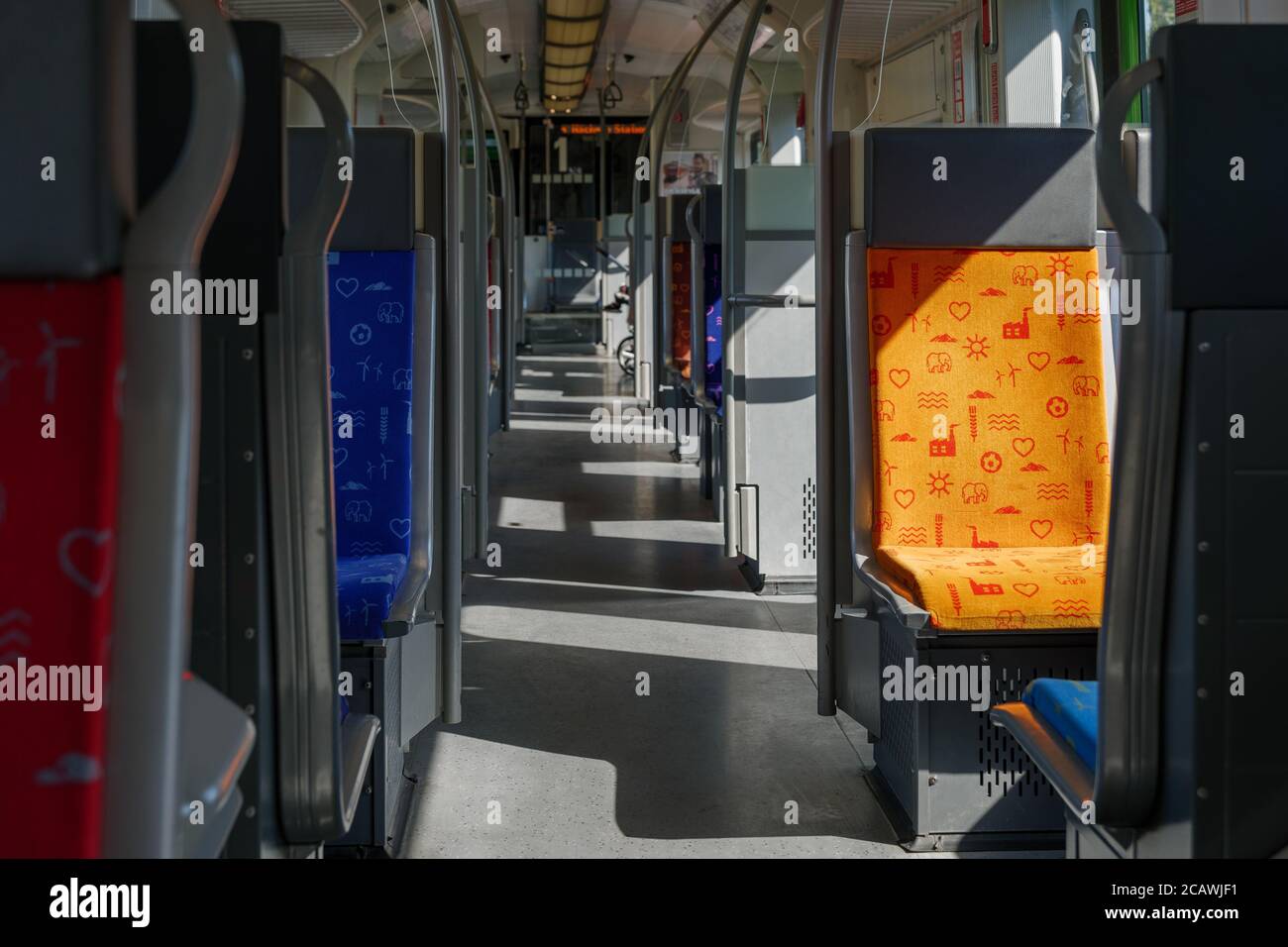 Corridor inside passenger trains with colourful fabric seats of German ...
