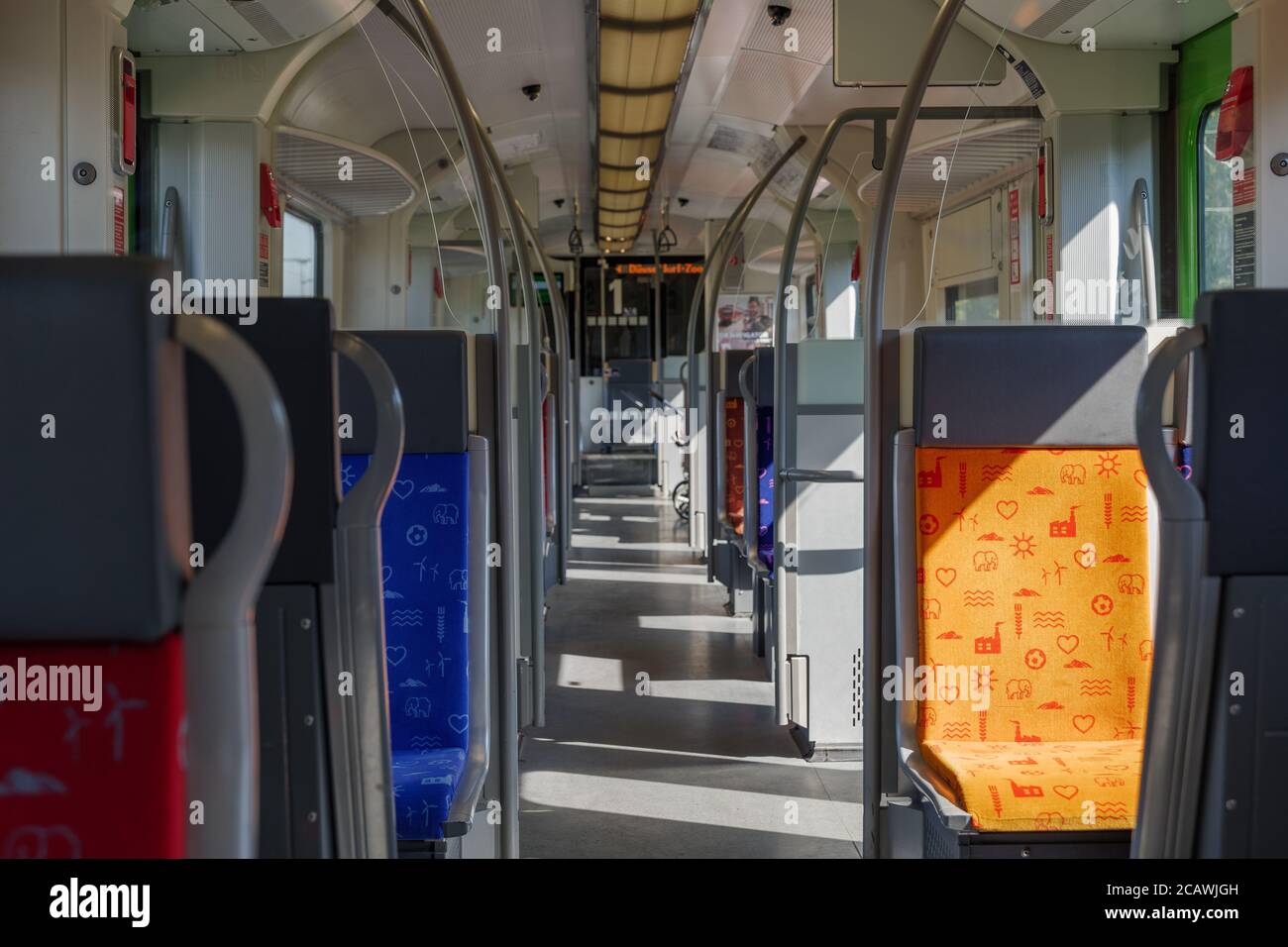 Corridor inside passenger trains with colourful fabric seats of German ...